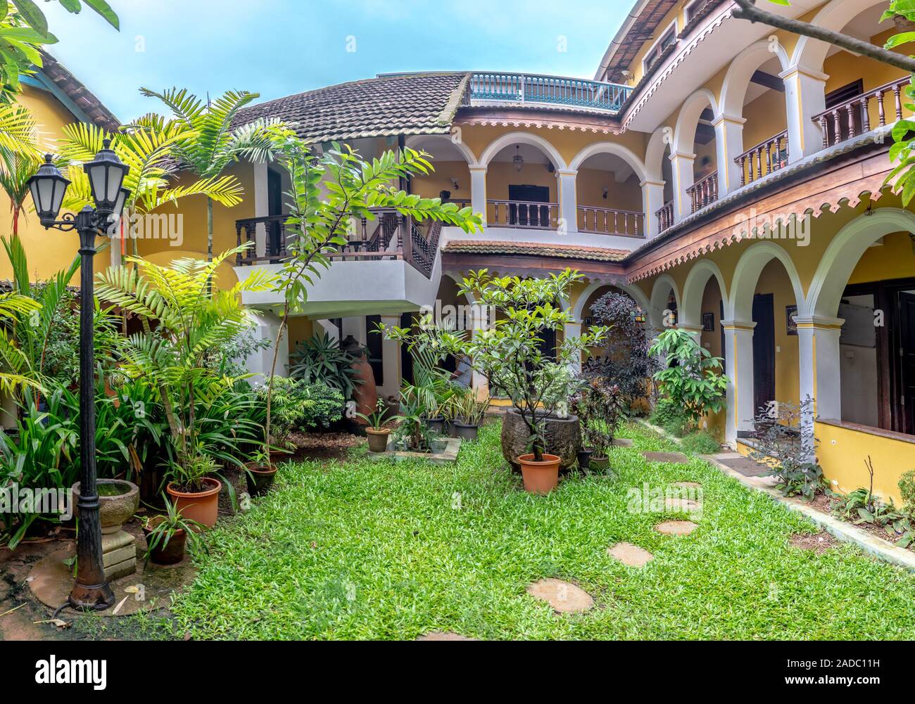 Enclosed green courtyard for relaxing in hotel with trees Stock Photo ...