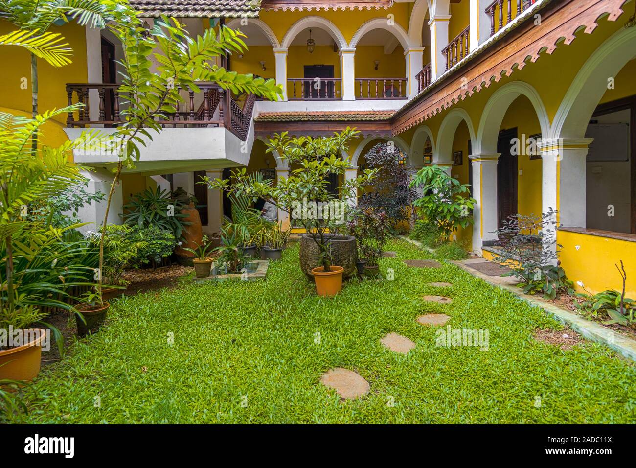 Enclosed green courtyard for relaxing in hotel with trees Stock Photo ...