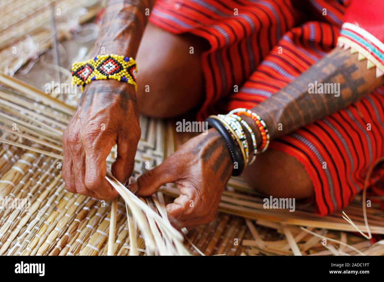 Close-up of master basket weaver Sulimbay Daosay's arm tattoos. These ...