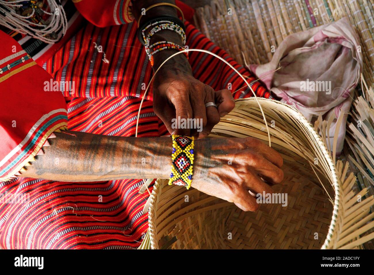 Close-up of master basket weaver Sulimbay Daosay's arm tattoos. These ...