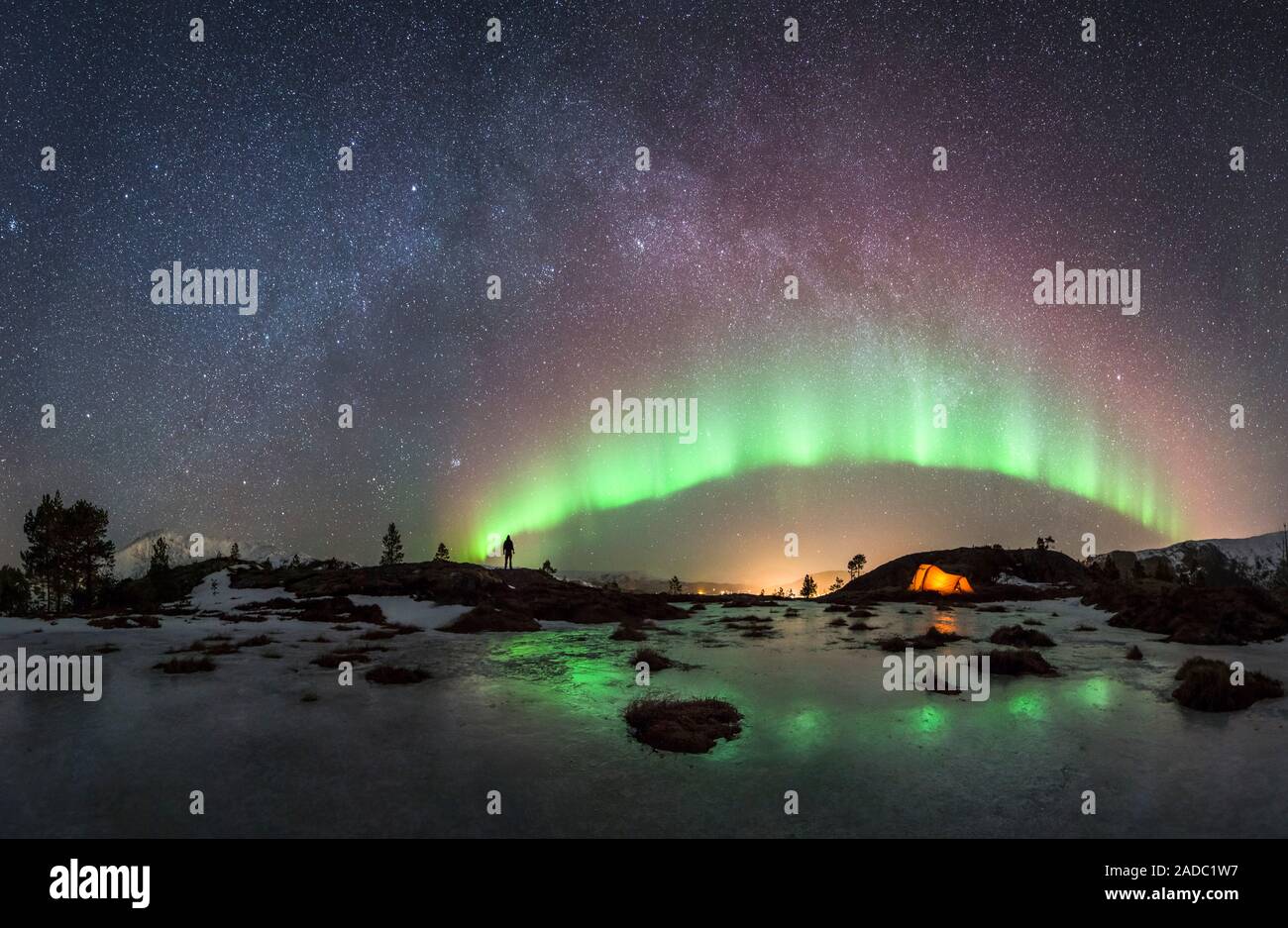 Watching the aurora borealis. Silhouetted human figure watching the ...