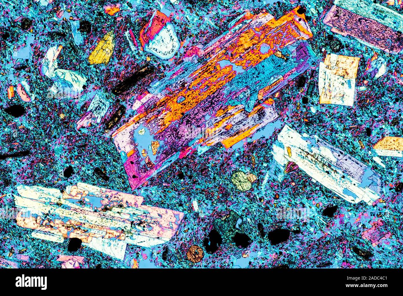 Rock mineral crystals, polarised light micrograph. This thin slice from ...