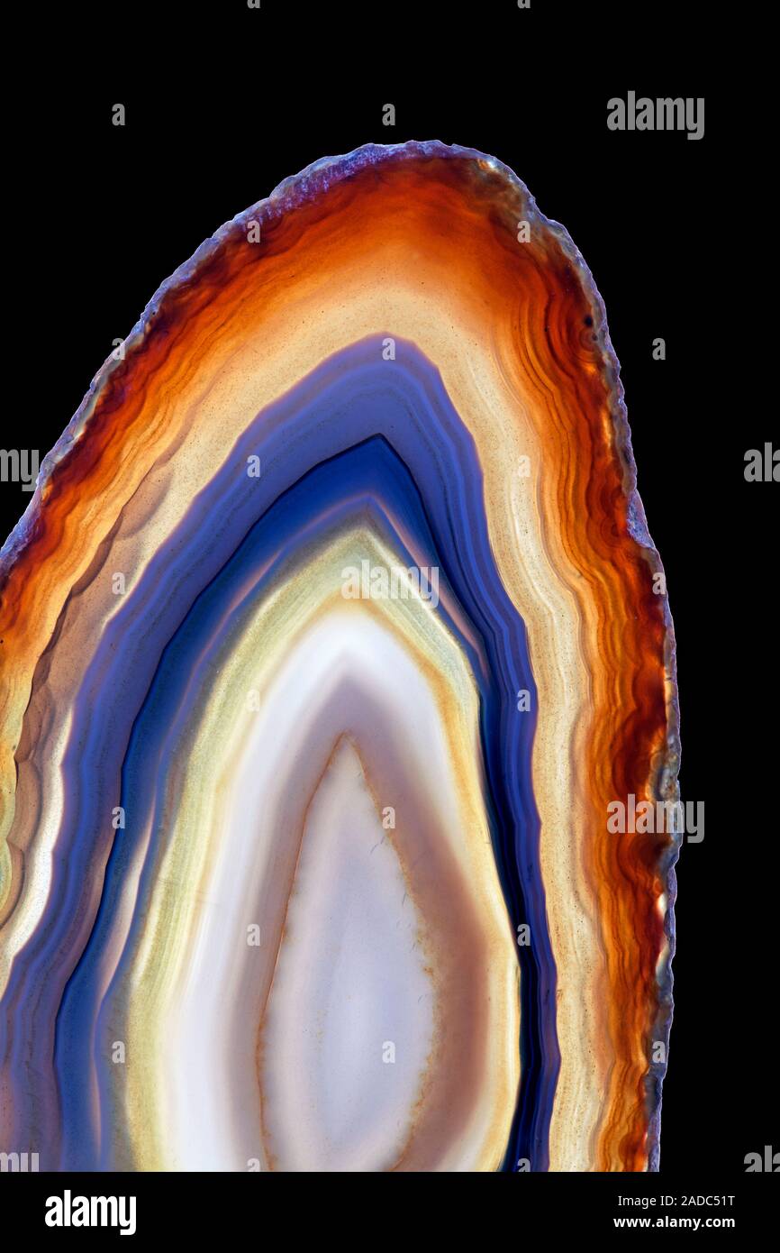 Concentric banding in a thin, translucent slice of agate in a geode ...
