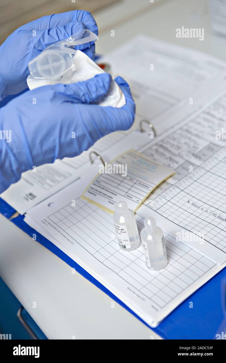 Preparing hospital drugs. Close-up of a hospital nurse preparing a ...