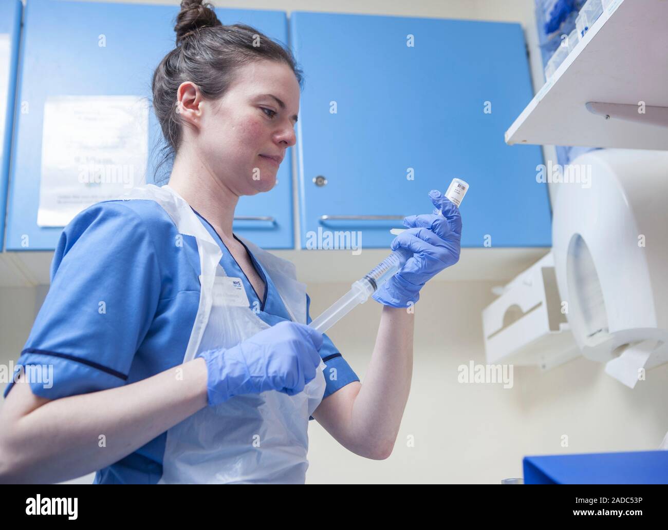 Preparing hospital drugs. Hospital nurse preparing intravenous drugs ...