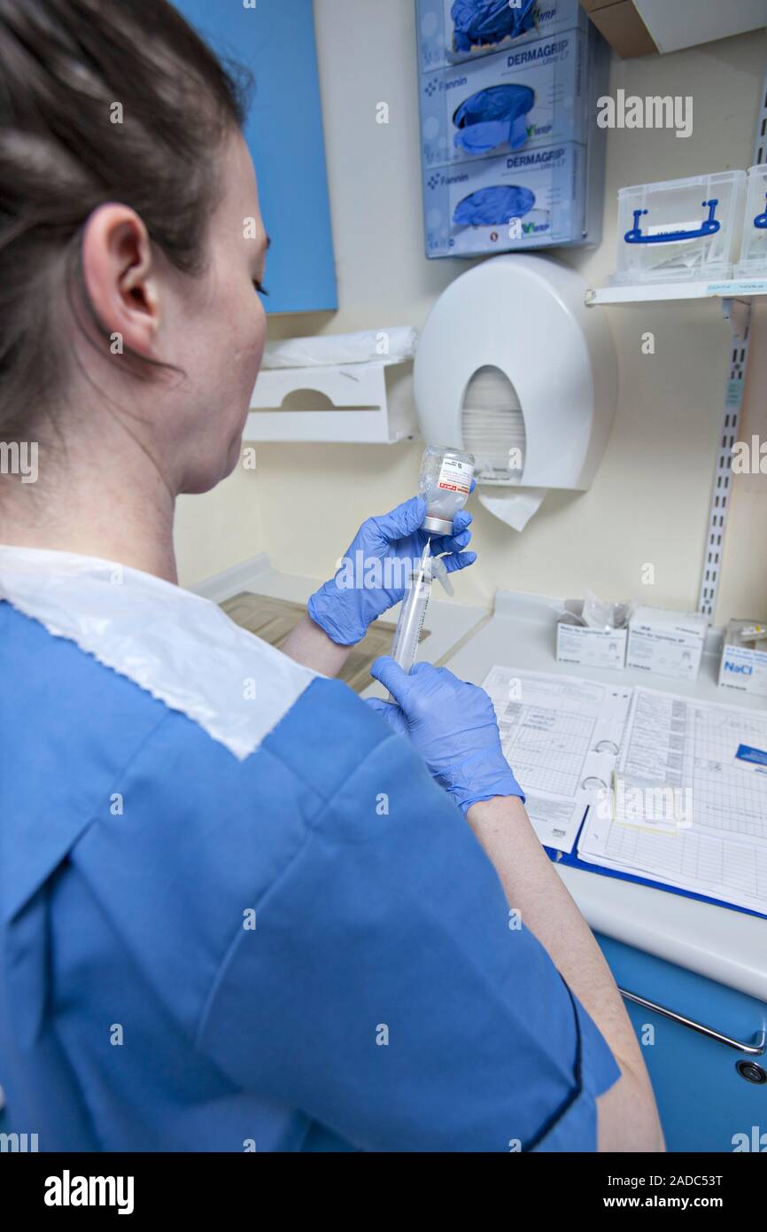 Preparing hospital drugs. Hospital nurse preparing intravenous drugs ...
