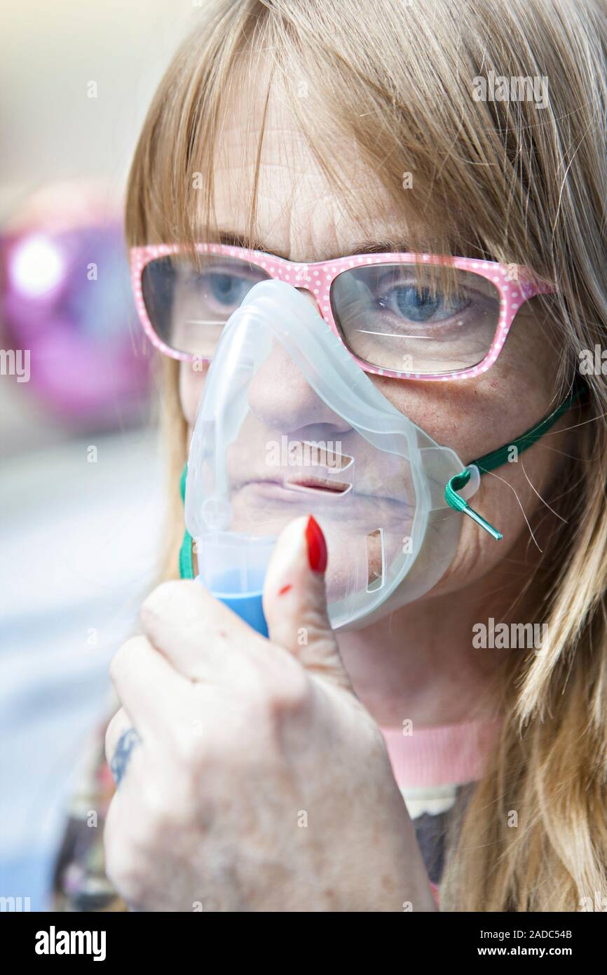 Patient with oxygen mask. Woman wearing an oxygen mask to help her ...