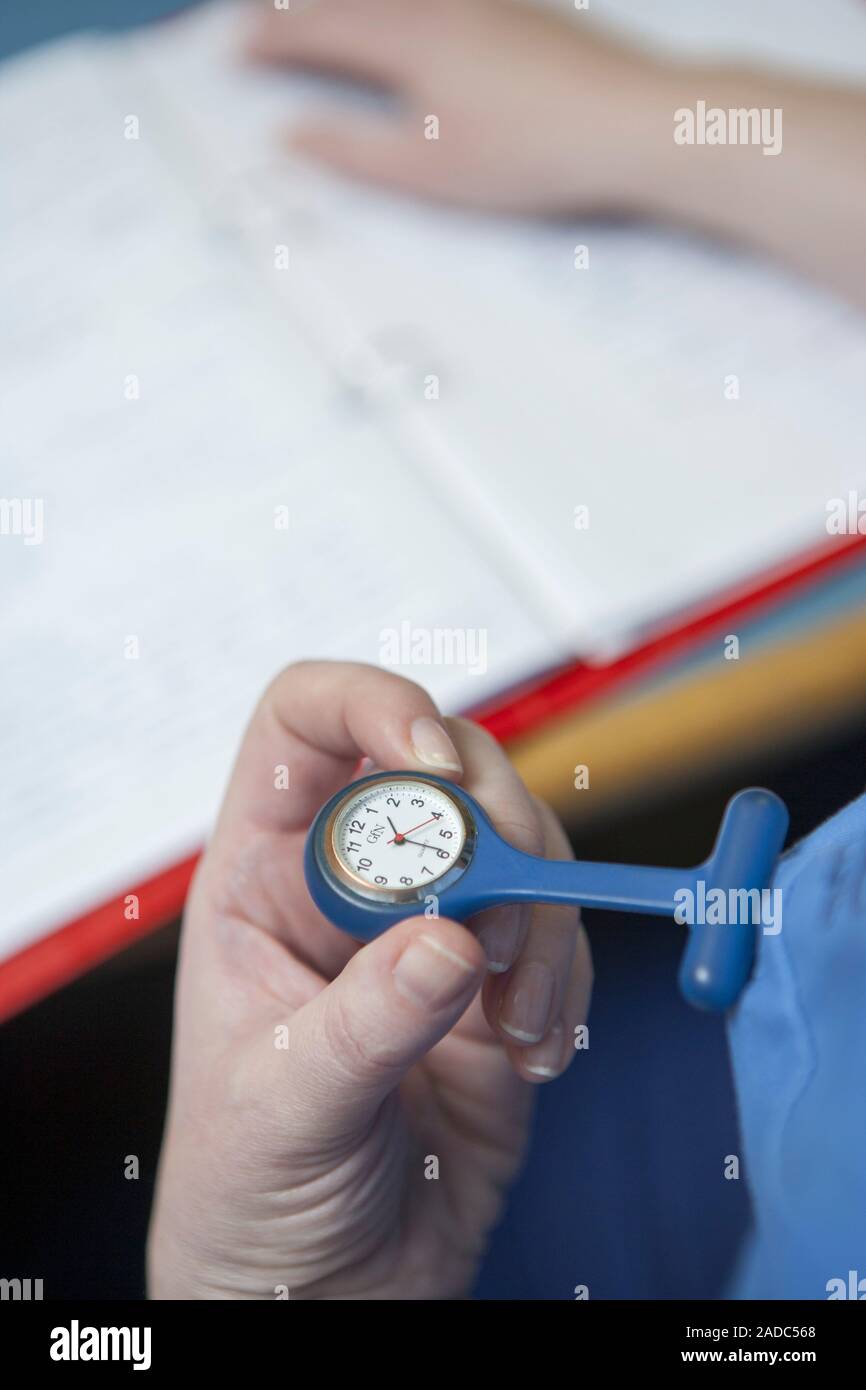 Timing of drug dispensing. Close-up of a hospital nurse using a chest ...