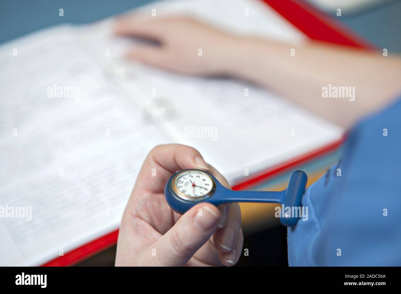 Timing of drug dispensing. Close-up of a hospital nurse using a chest ...