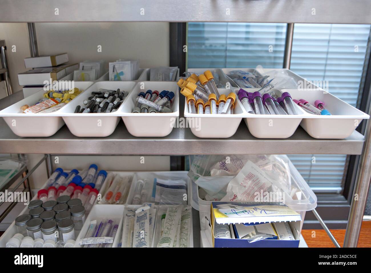 GP sampling equipment. Trolley of various sampling containers in a ...