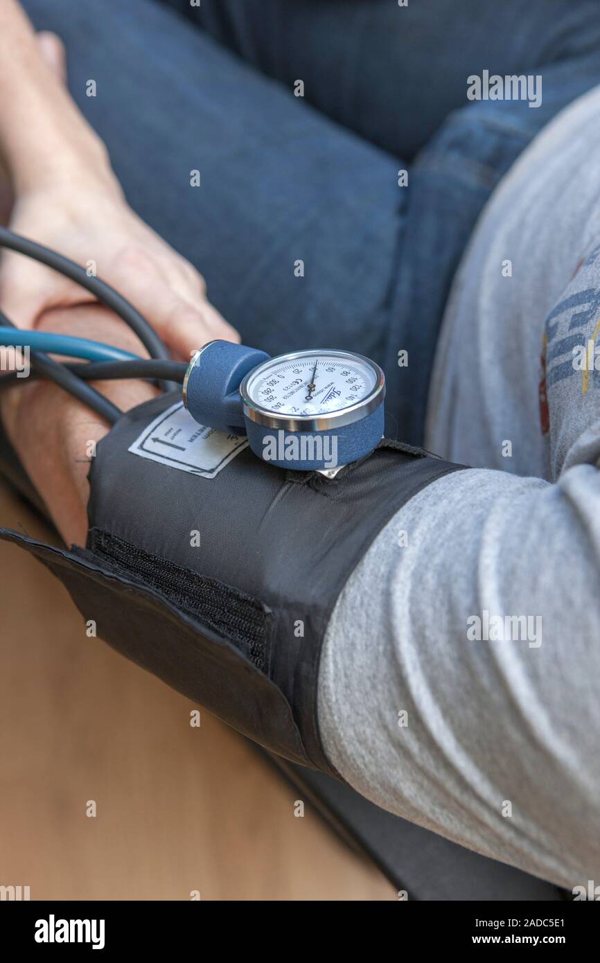 Blood pressure measurement. Sphygmomanometer being used by a medical ...