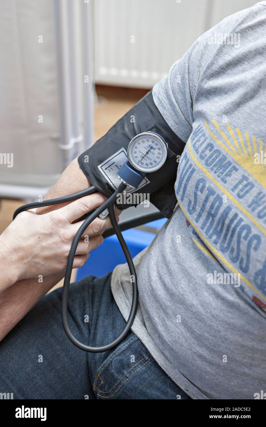 Blood pressure measurement. Sphygmomanometer being used by a medical ...