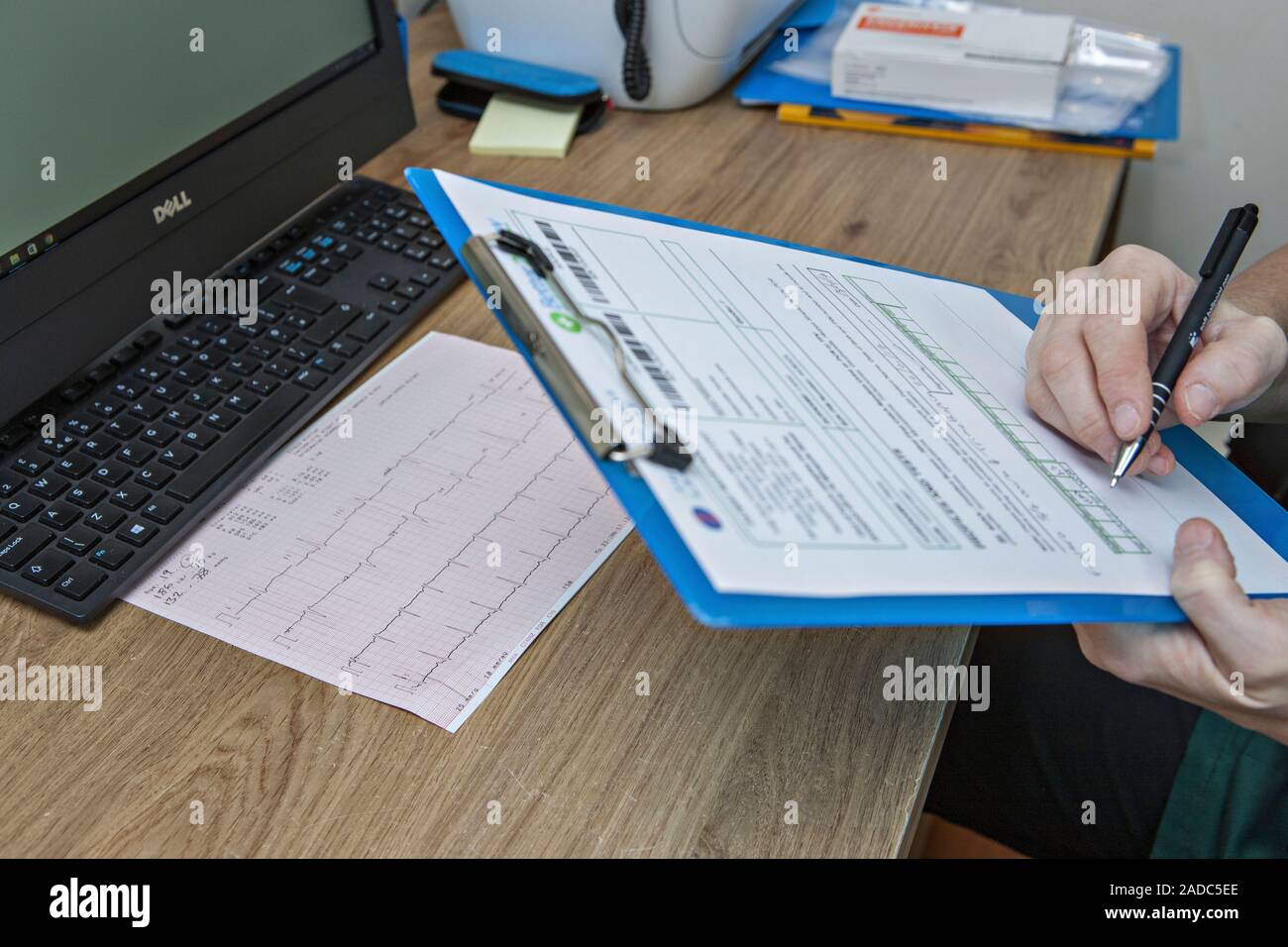 Electrocardiography test results and notes. Medical practitioner making ...