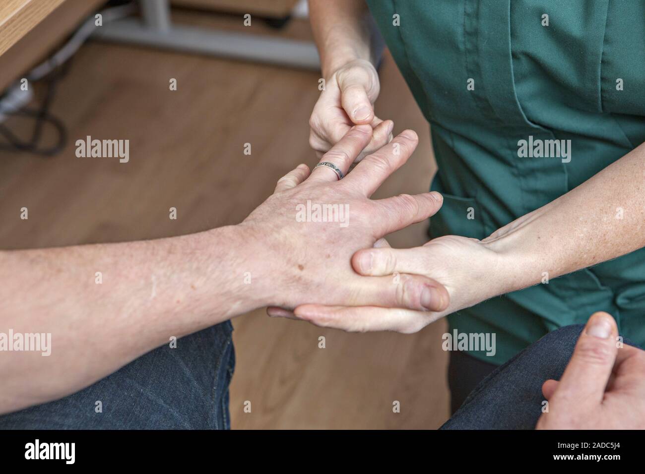 Carpal tunnel syndrome examination. Paramedic examining the hand of a ...