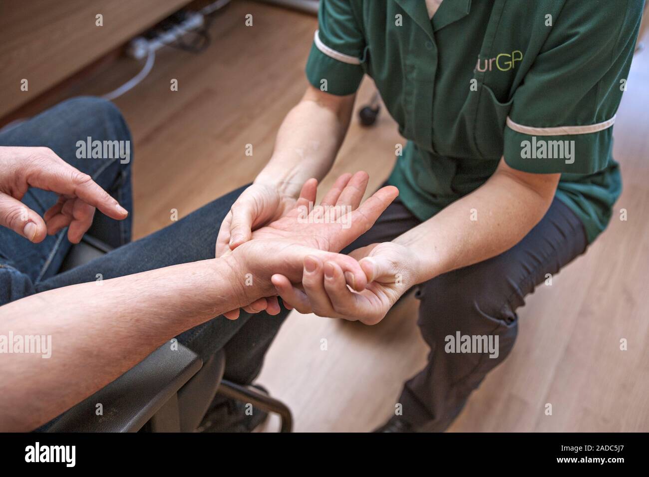 Carpal tunnel syndrome examination. Paramedic examining the hand and ...