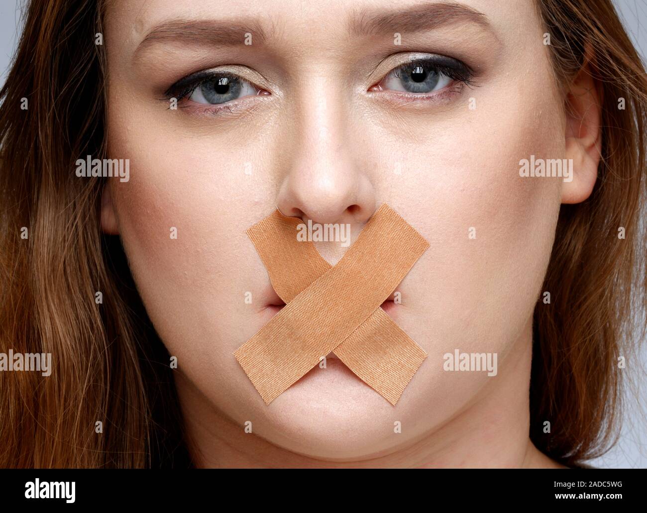 Suppressing free speech. Conceptual image of a woman with her mouth ...