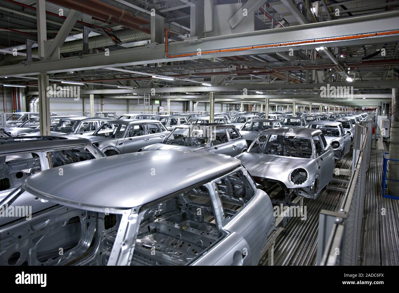 Mini car factory. Completed Mini body shells in the upper storage ...