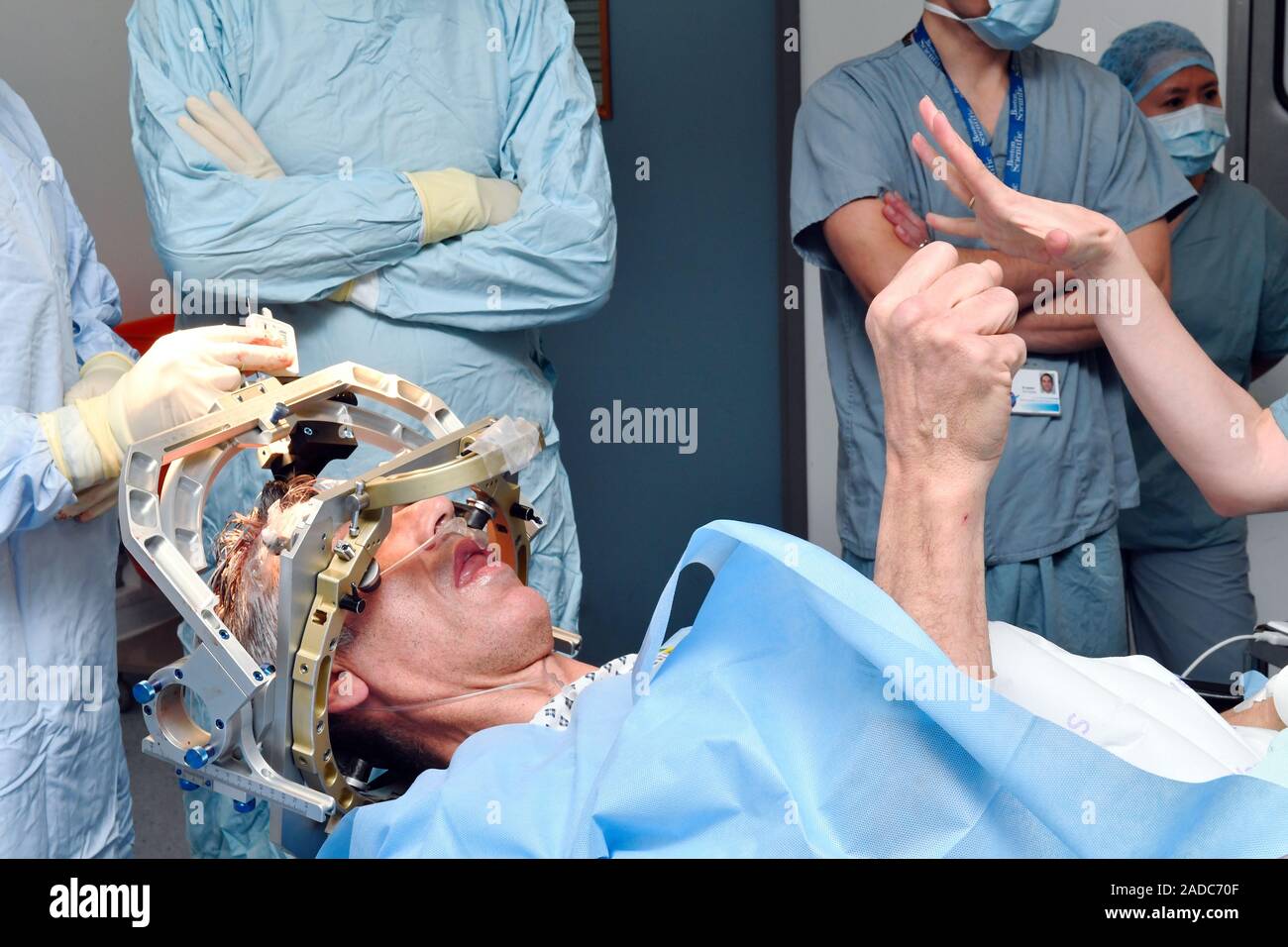 Deep brain stimulation surgery. Neurological test being carried out on ...