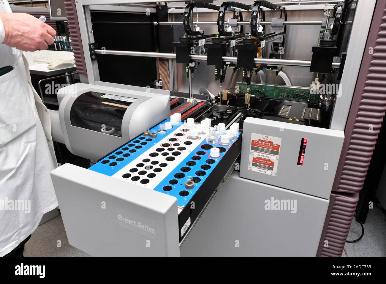 Blood sample coagulation analysis. Technician handling samples of blood ...