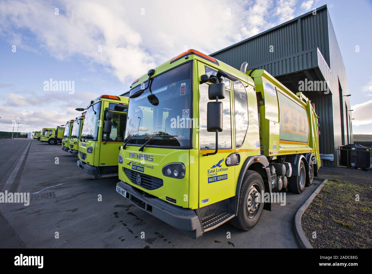 Recycling centre. Kerbside refuse lorries parked up at a recycling ...