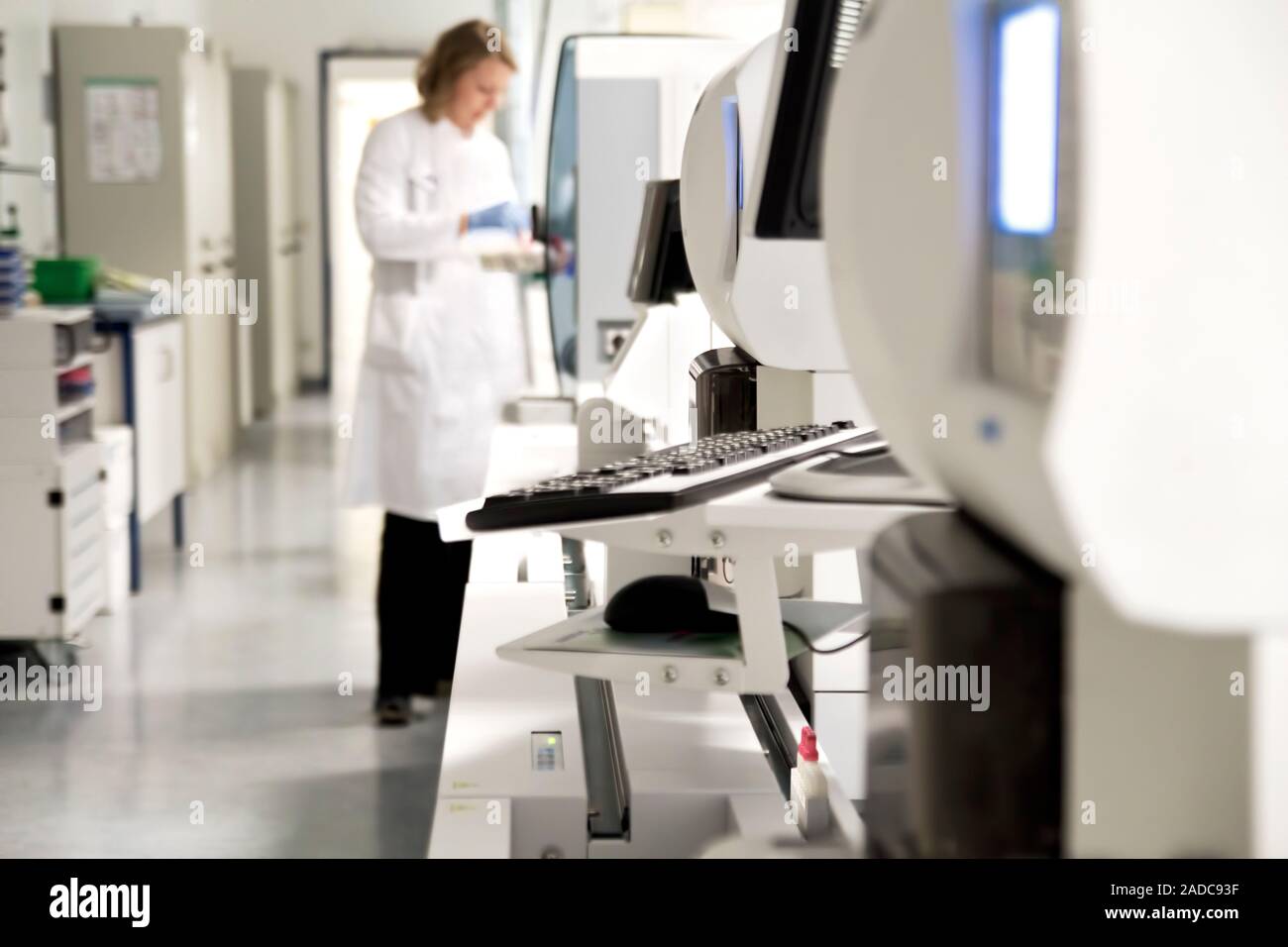 Laboratory flow cytometry analysis. Researcher handling samples while ...