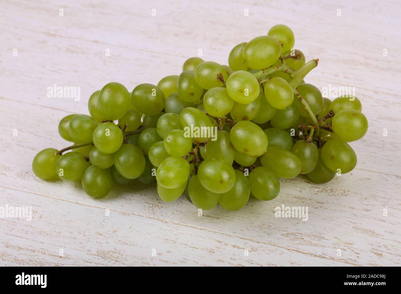 Sweet green grape branch over background Stock Photo - Alamy