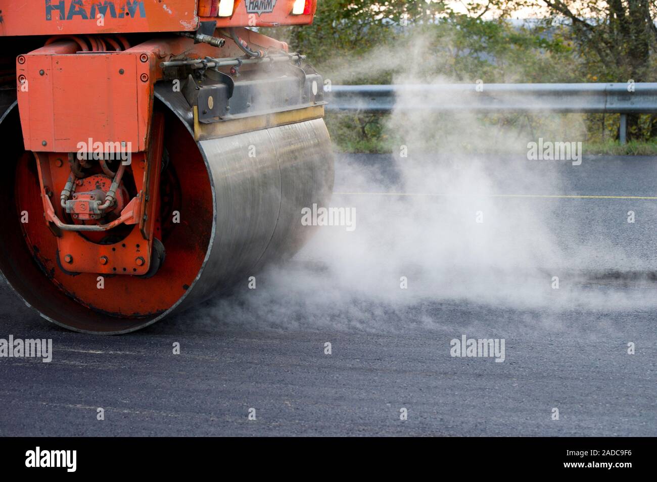 Road-laying roller being used to laid tarmac on a road. Photographed in ...