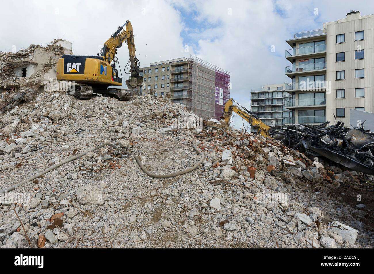 Building demolition. Demolition machines demolishing a building ...