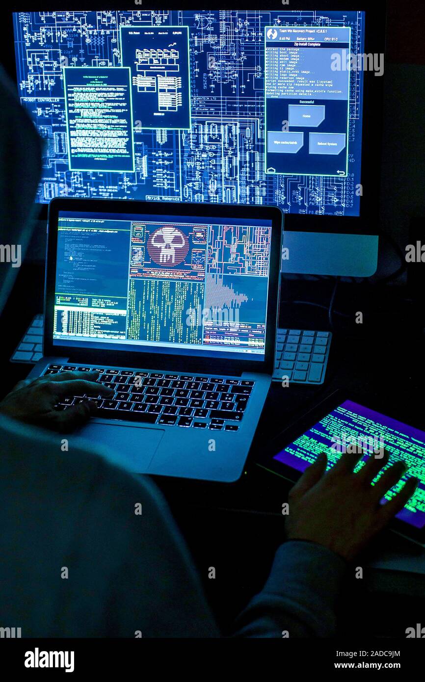 Computer hacking culture. Computer hacker typing on a laptop surrounded ...