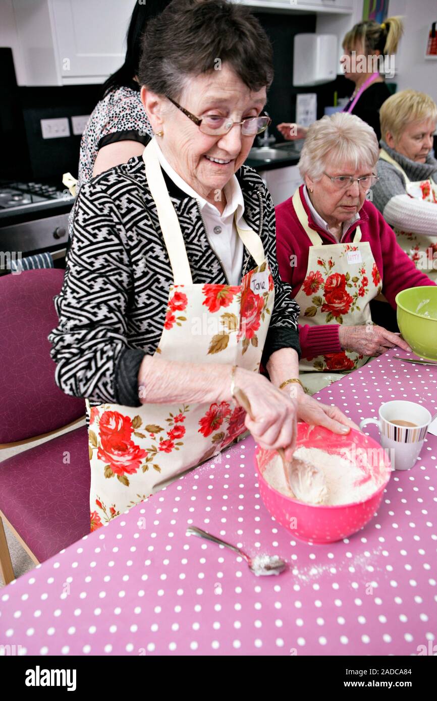 Dementia awareness fundraiser. Alzheimer's patients making cakes at a ...