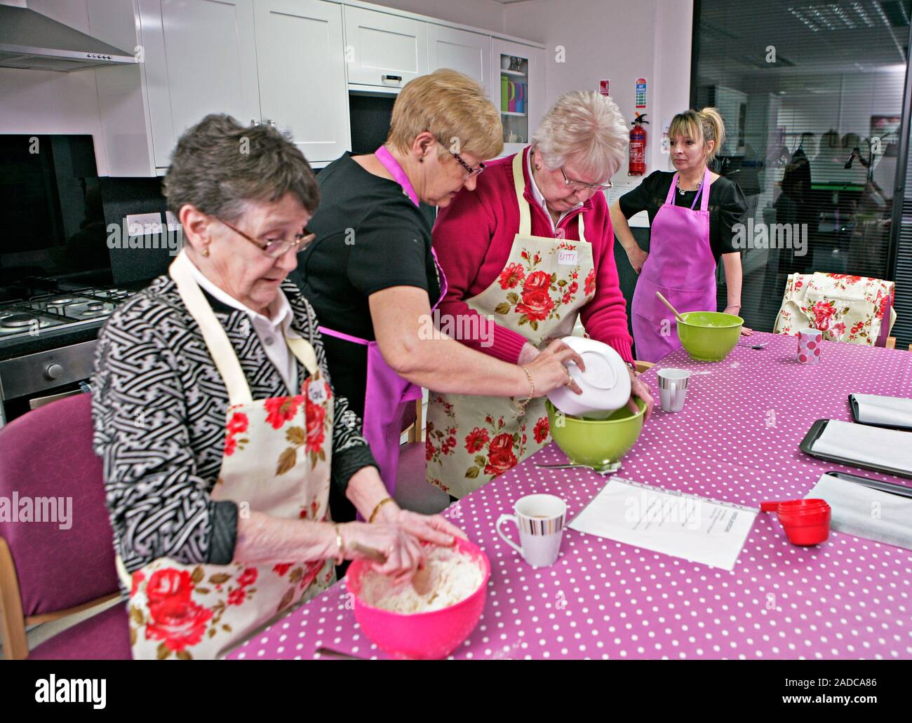 Dementia awareness fundraiser. Alzheimer's patients making cakes at a ...
