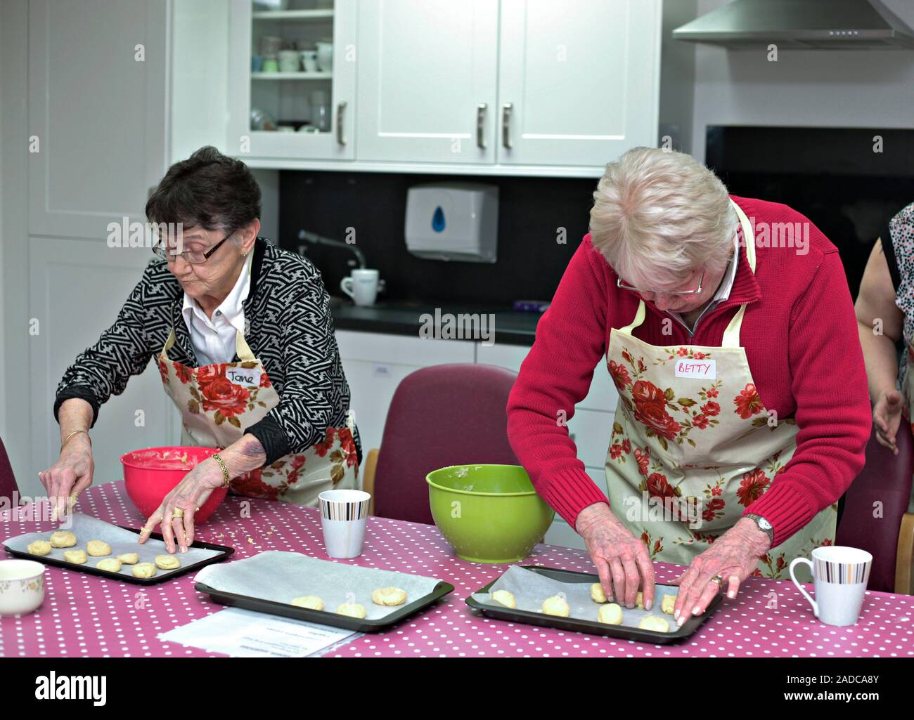 Dementia awareness fundraiser. Alzheimer's patients making cakes at a ...