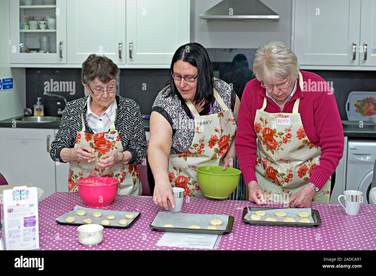 Dementia awareness fundraiser. Alzheimer's patients making cakes at a ...