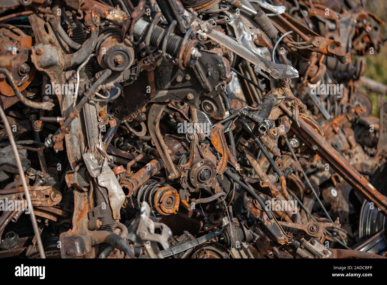 Scrapyard. Dismantled vehicle parts ready for recycling at a scrapyard ...