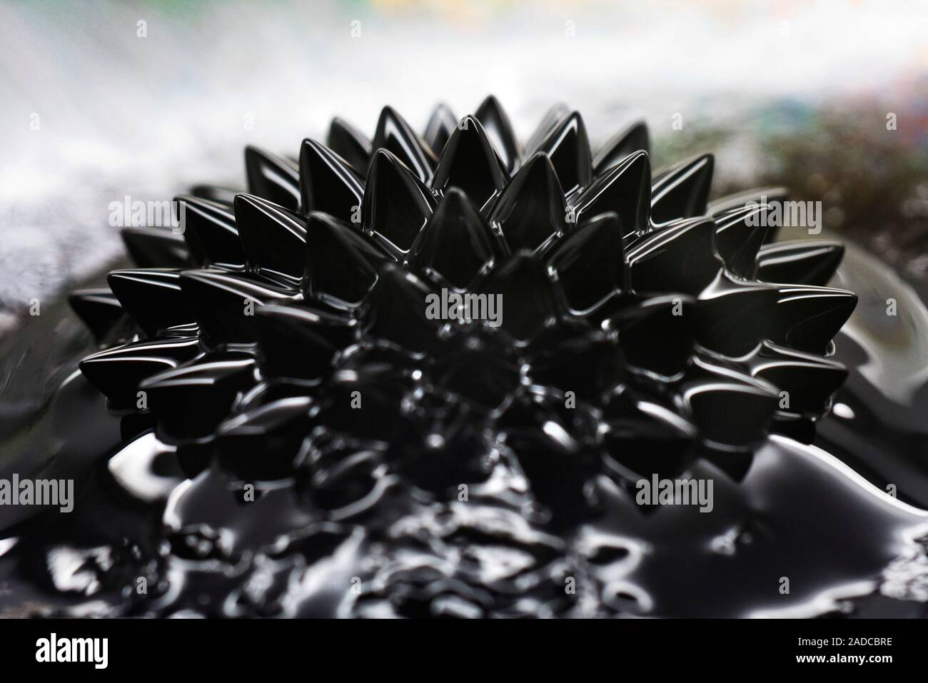 Macro photograph of ferrofluid being exposed to a magnetic force ...