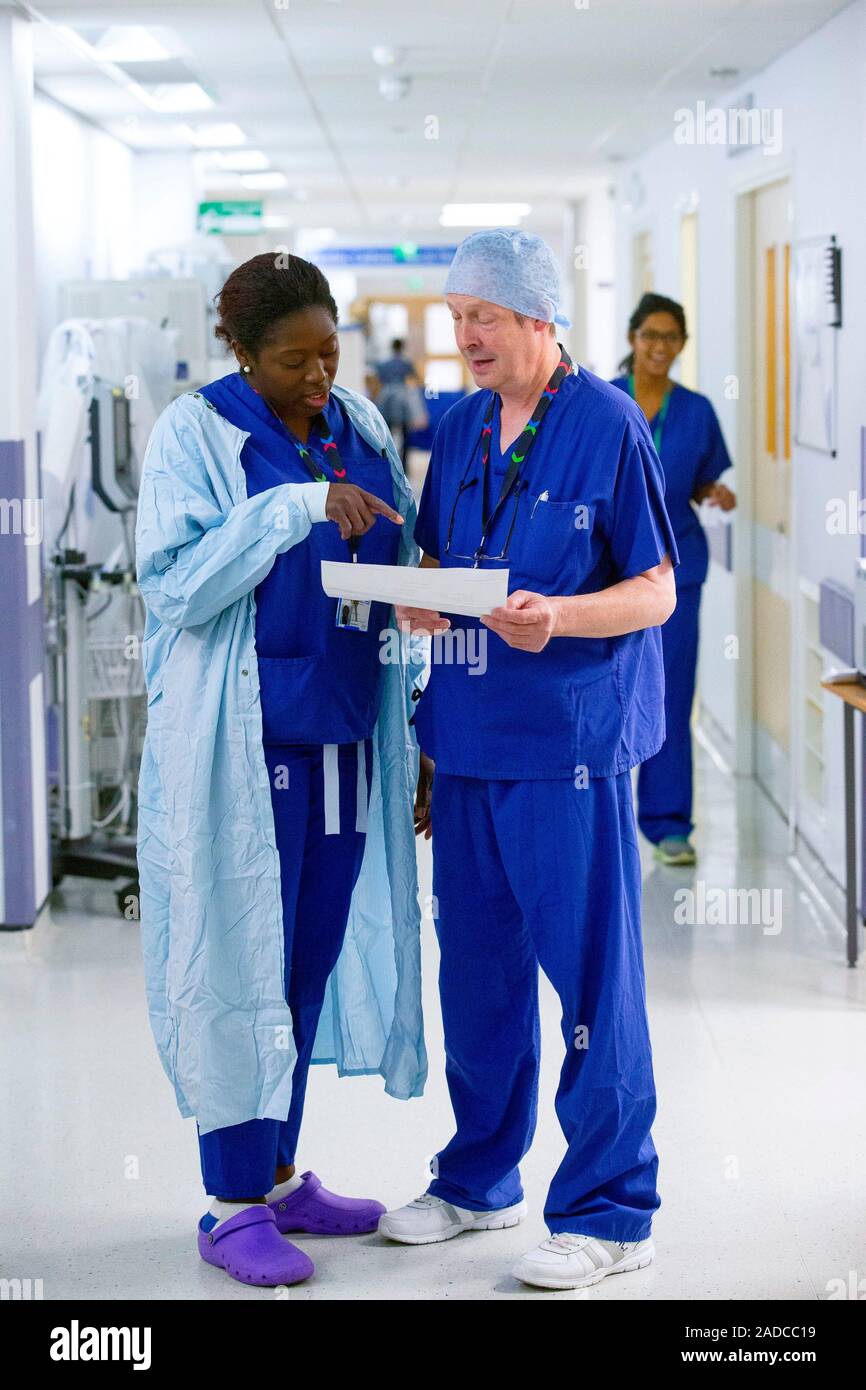 Hospital surgeons talking in a corridor. Photographed in the UK Stock ...