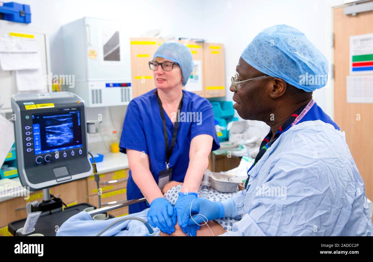 Ultrasound examination and surgery. Surgeons using an ultrasound ...