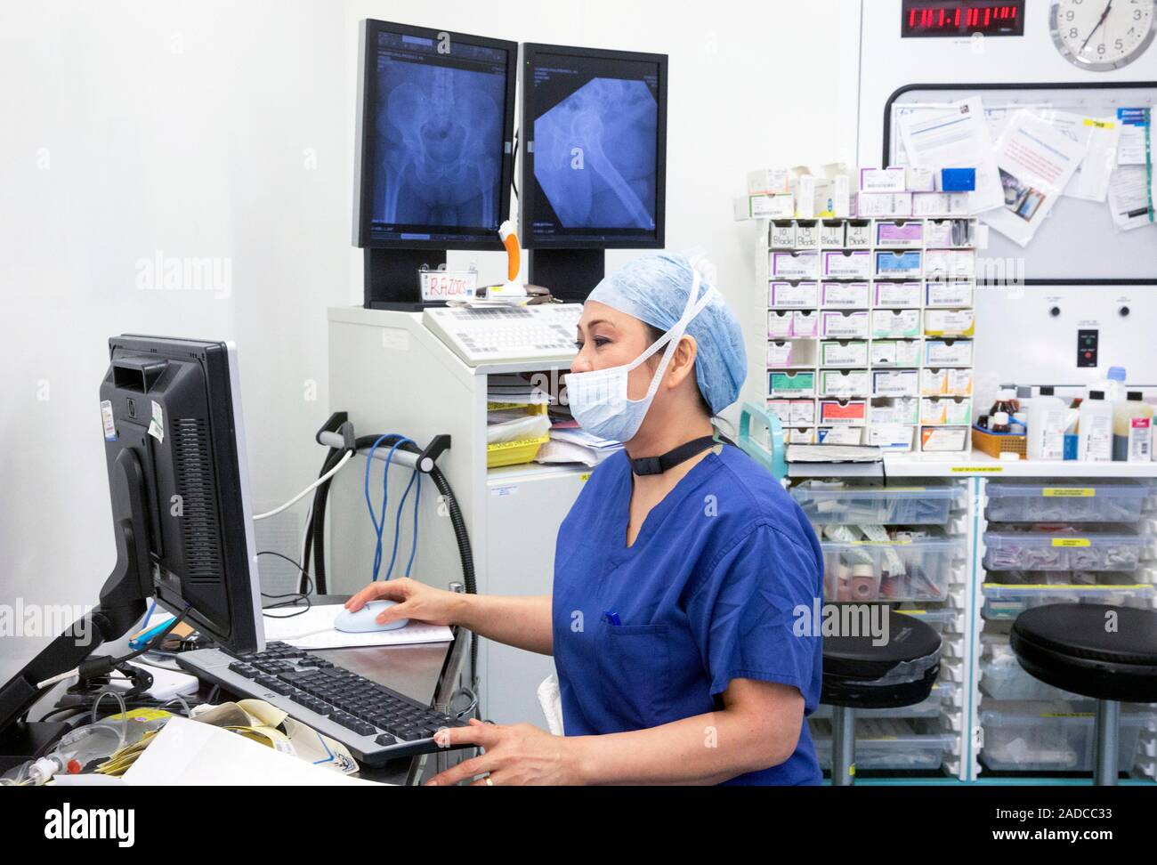 Hip replacement surgery planning. Surgical team member examining ...