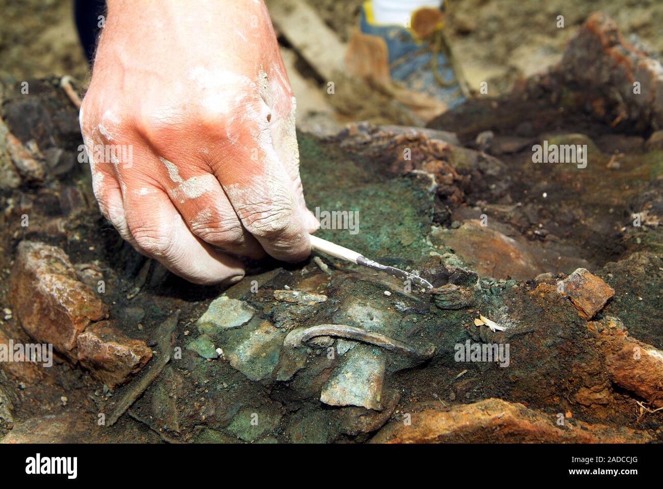 Excavation of an Iron Age tomb. Close-up of an archaeologist excavating ...