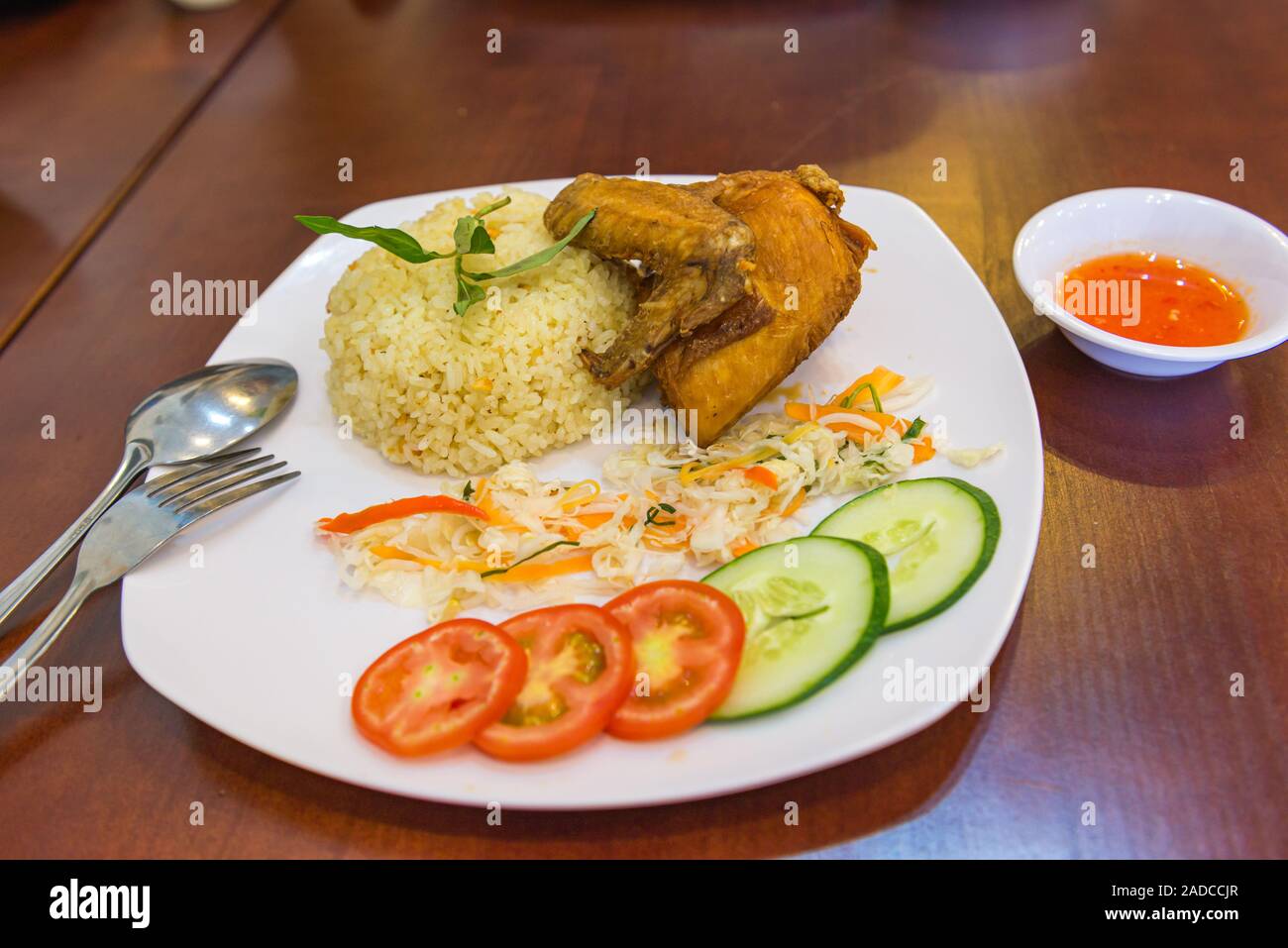 Delicious fried chicken wing served with rice and vegetables Stock ...