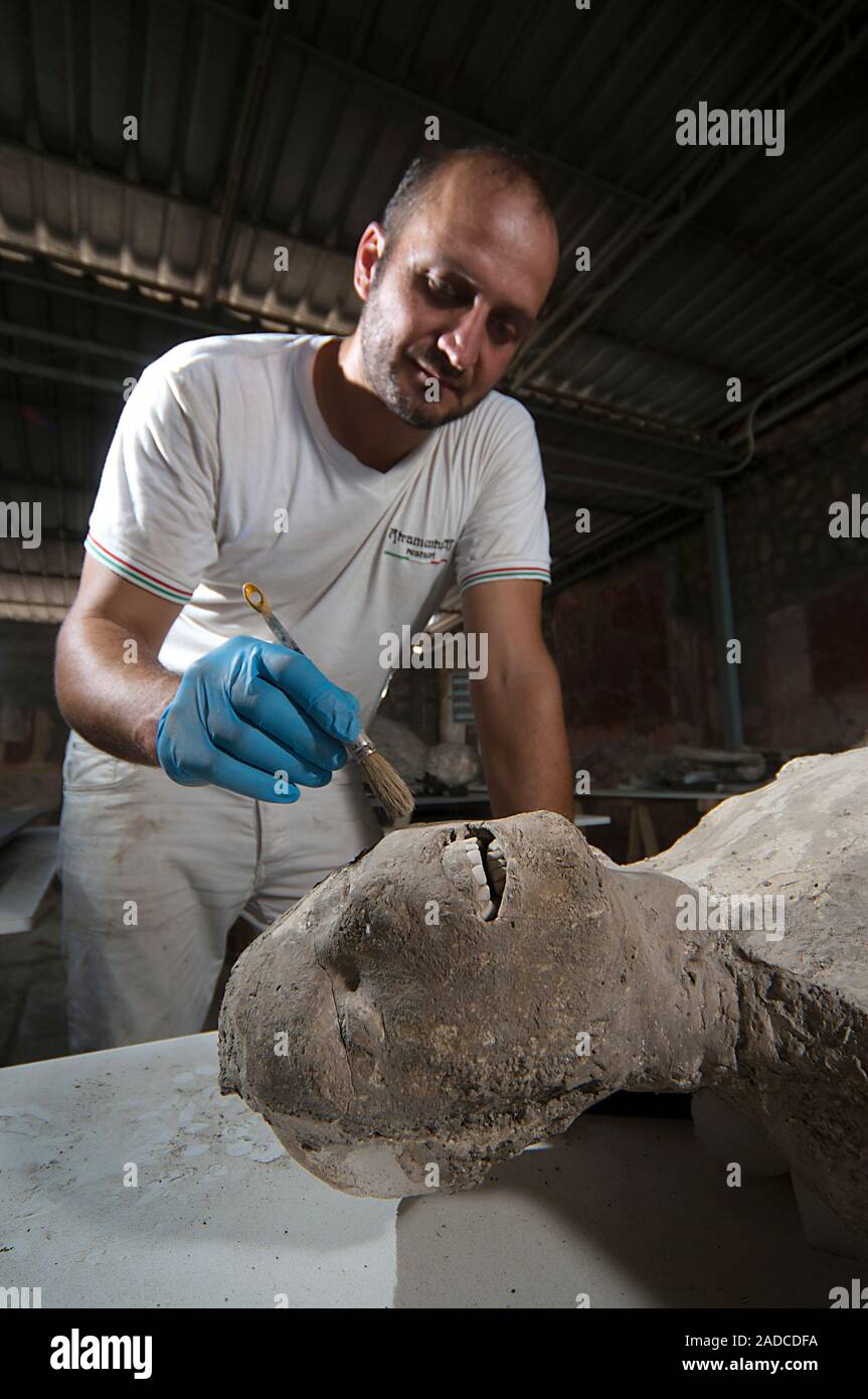 Preservation work being carried out on a body cast of a victim of the ...