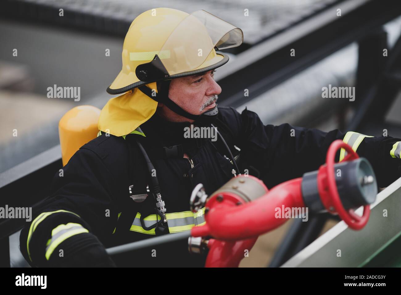 Bucharest, Romania - December 03, 2019: Firefighter holds a fire ...