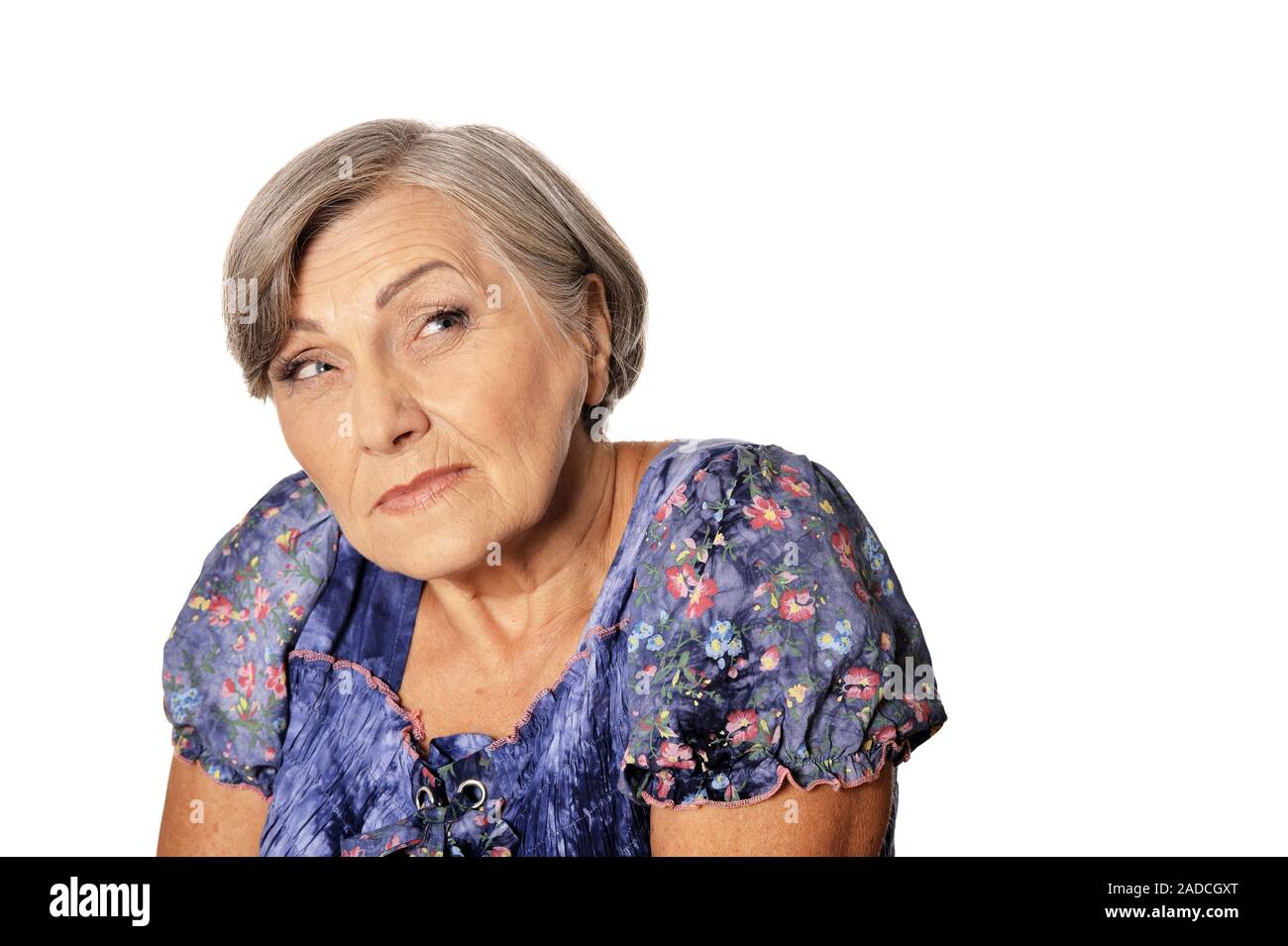 Suspicious beautiful senior woman posing isolated on white background ...