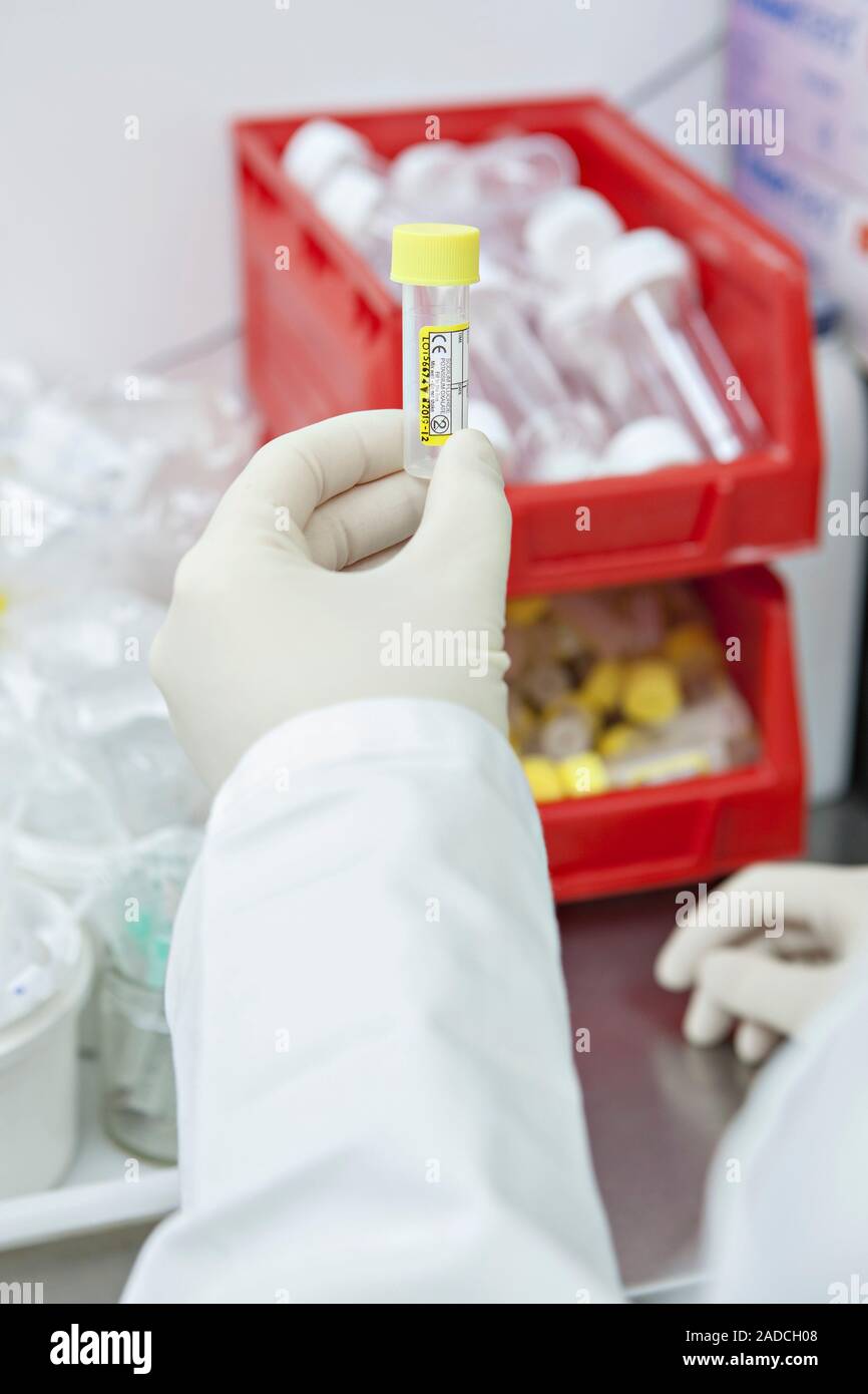 Autopsy room. Mortuary worker holding an autopsy specimen jar Stock ...