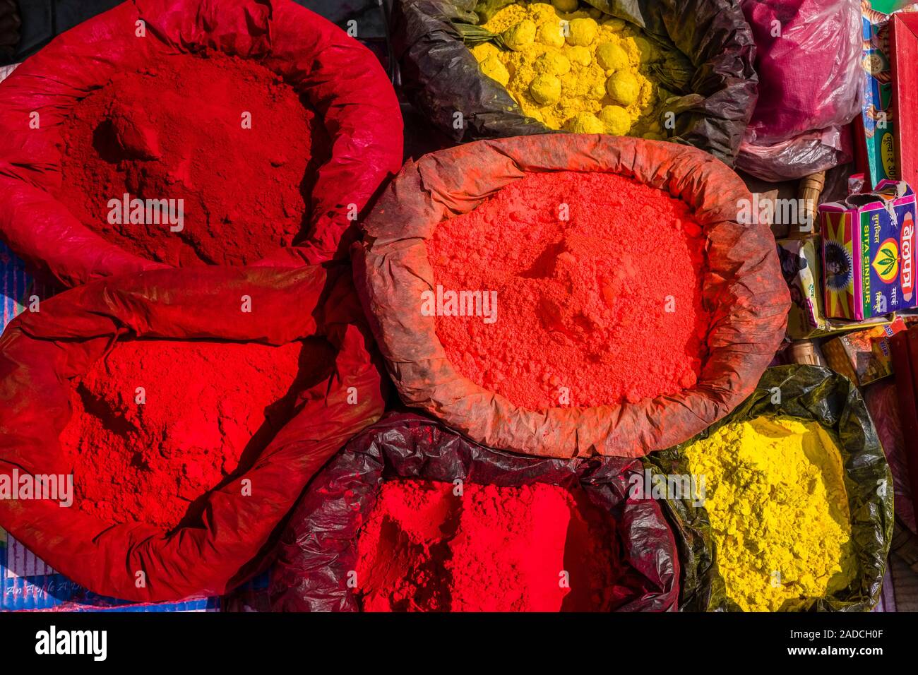Red, orange and yellow color powder in little sacks for sale at the ...