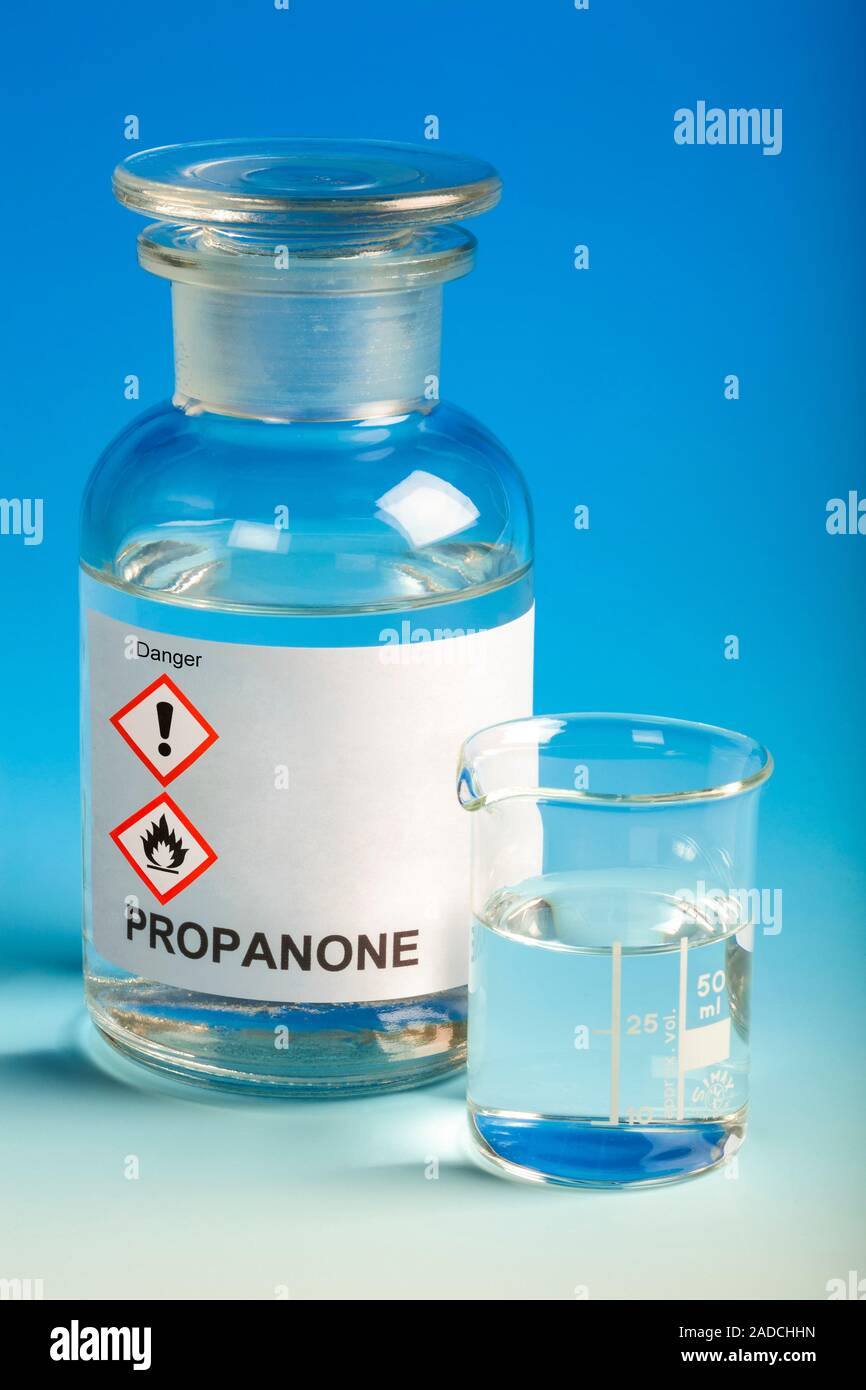 Laboratory stoppered glass bottle and beaker of propanone. Also known ...