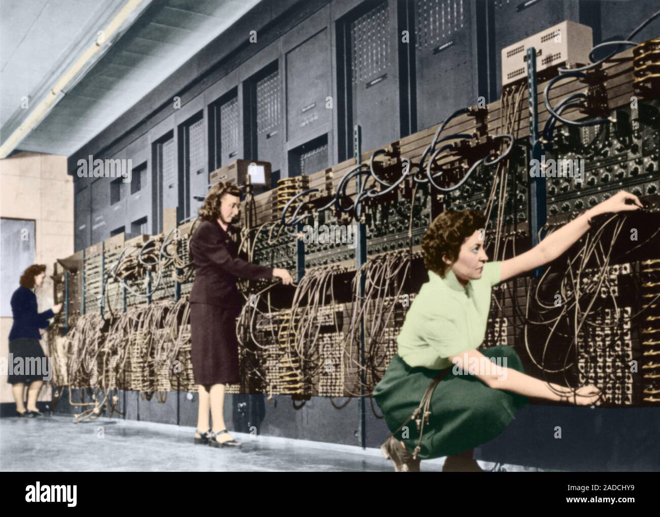 ENIAC digital calculator. Technicians connecting the wiring of the ...