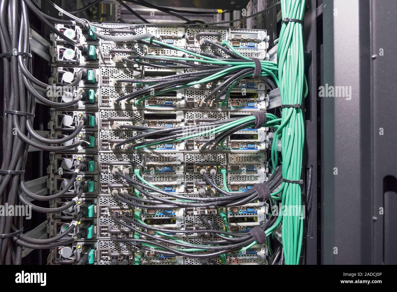 Datacentre. Network (right) and power (left) cables plugged into the ...
