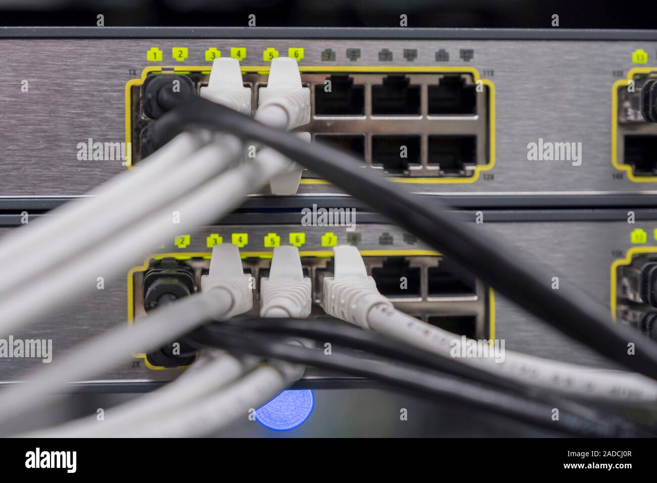 Close-up of ethernet ports and cables in the back of servers in a data ...
