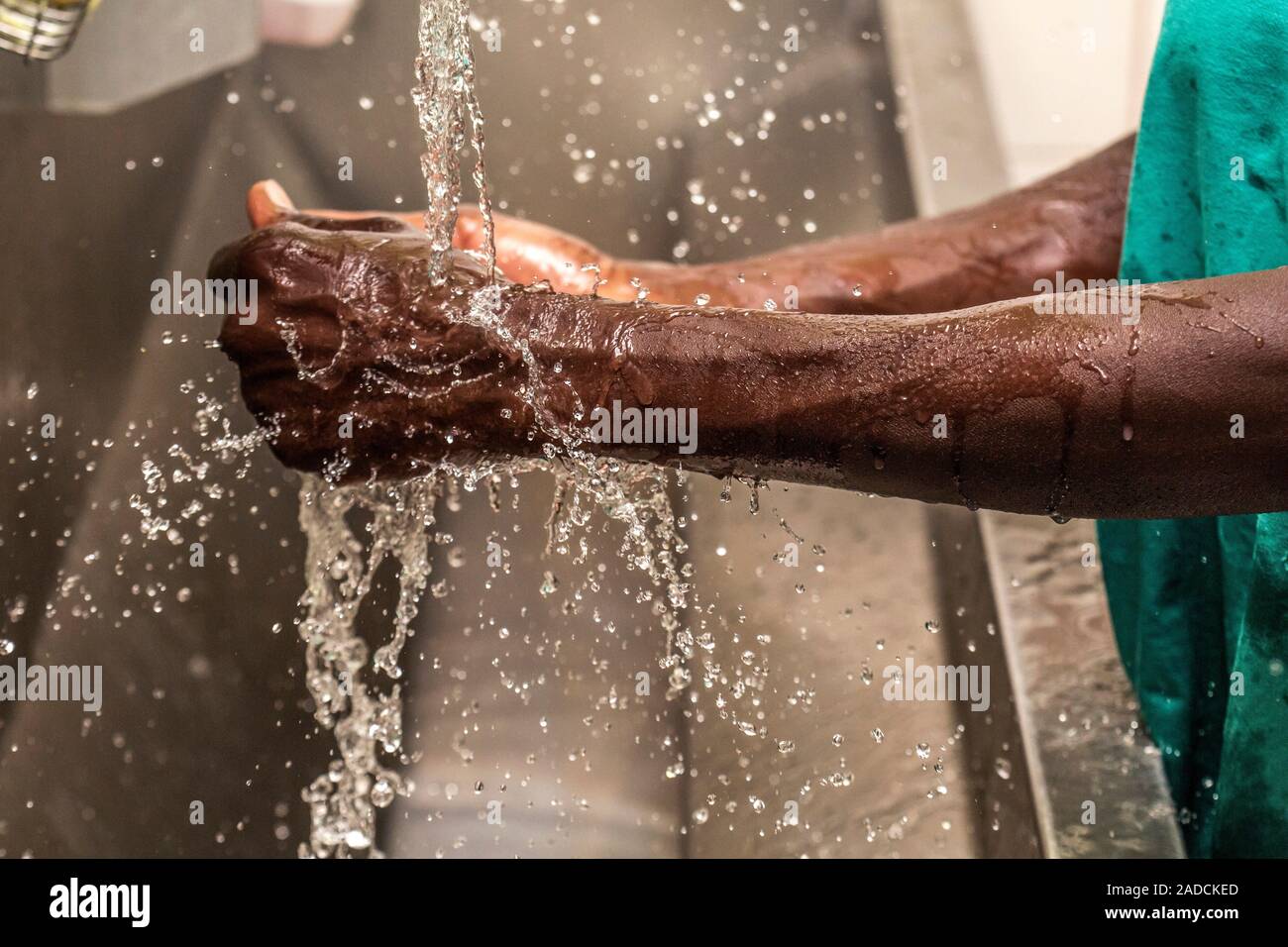 Surgeon washing her hands. Hospital surgeon cleaning her hands with ...